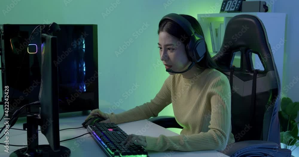 Young Asian woman gamer having live stream and playing in Online Video ...