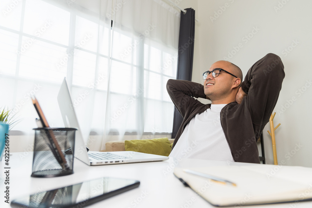 Young asian businessman finish the job turn off laptop and take a rest ...