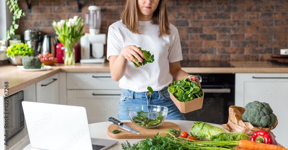 Close up woman in white t-shirt cooking salad with motion effect at ...