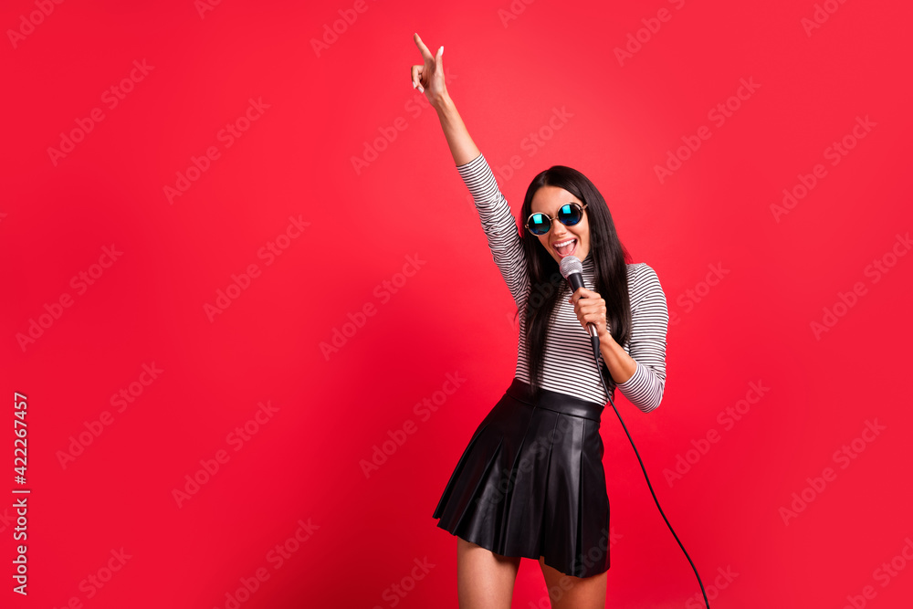 Portrait of attractive cheerful cool long-haired girl vocalist singing ...
