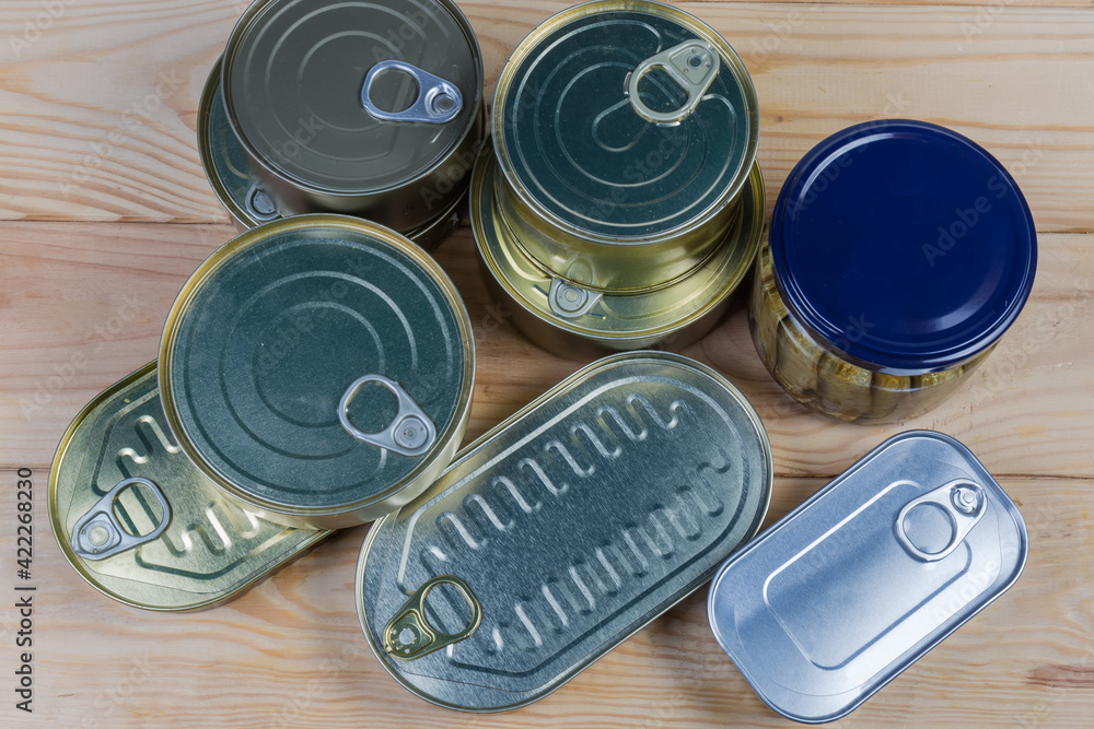 Canned fish in tin cans and glass jar, top view Stock Photo | Adobe Stock