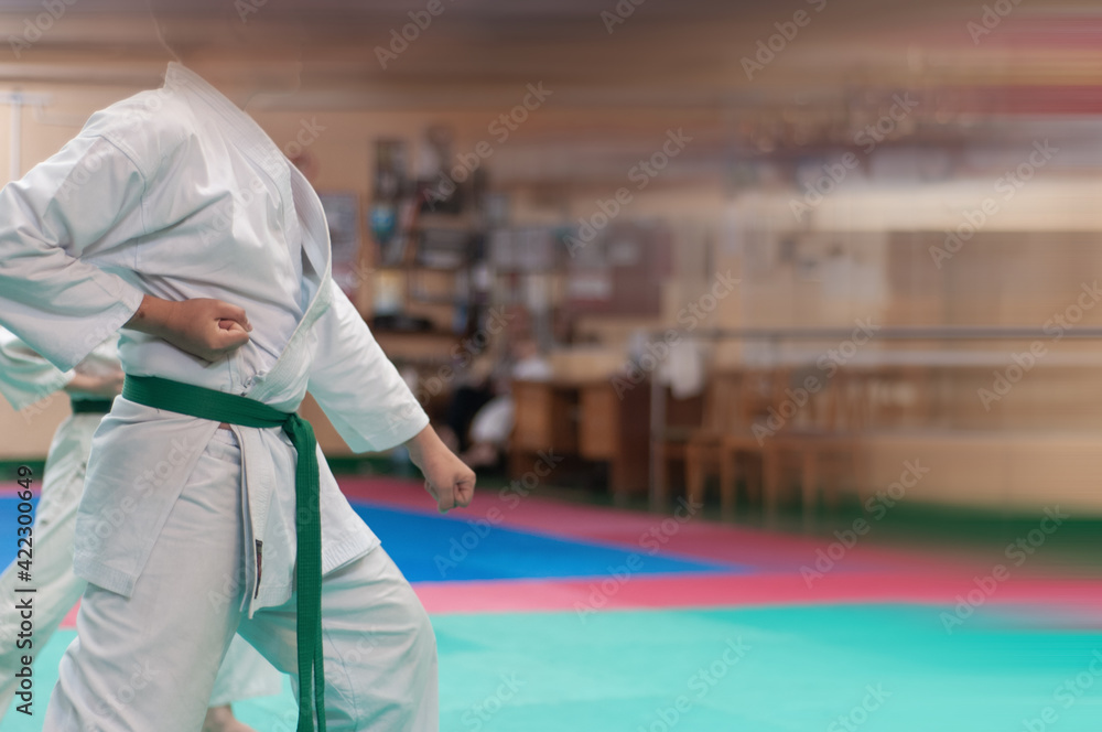 Foto de Karate-do training for teenagers. An athlete in a white kimano ...