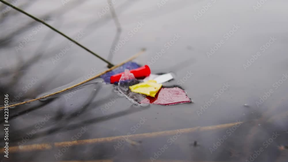 Residue of plastics in a river stream. Sea shore polluted with ...