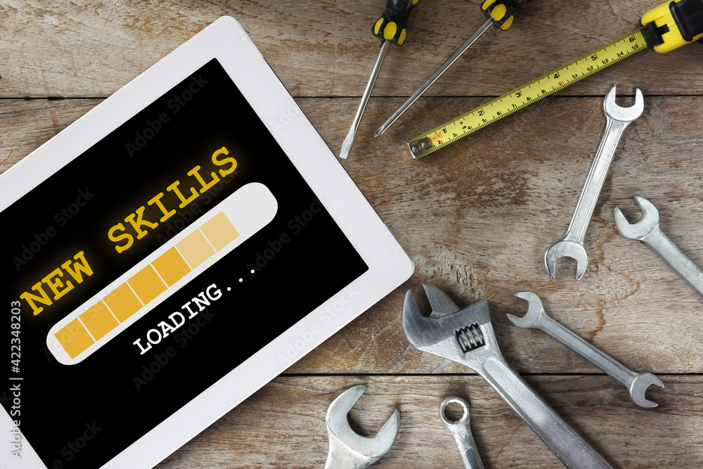 New skills loading on digital computer tablet and tools supplies on ...