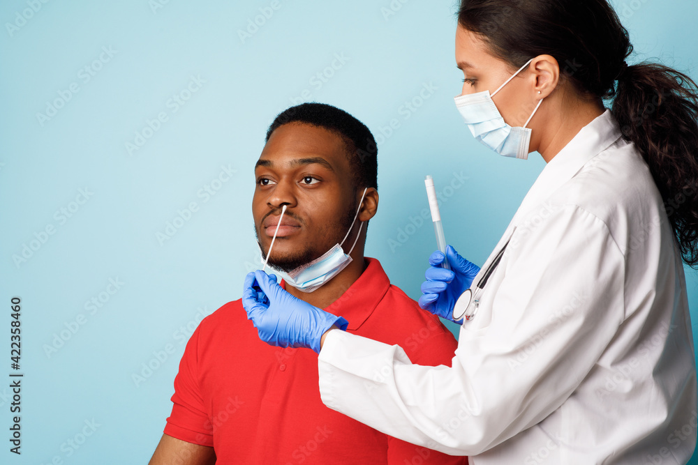 Doctor Making Covid-19 PCR Test For Male Patient, Blue Background Stock ...