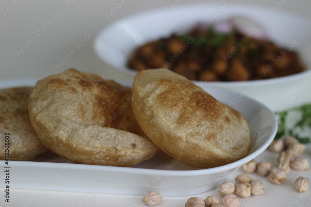 Fluffy whole wheat fried Indian flat bread, served along with Spicy ...
