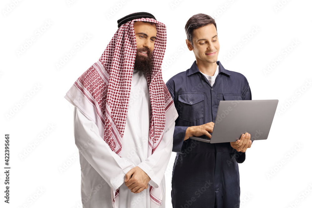 Auto mechanic showing a laptop computer to a saudi arab man Stock Photo ...