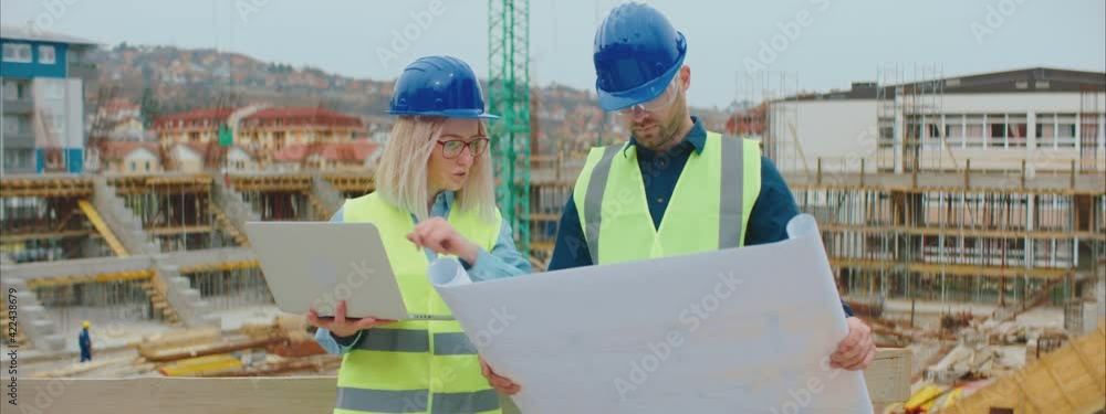An Engineer and an Architect examining the engineering diagram ...