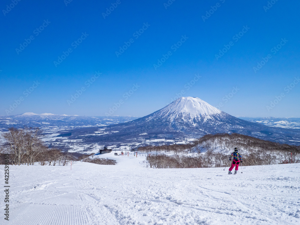 Looking at ski resort and snowy volcano on a clear day in early spring ...