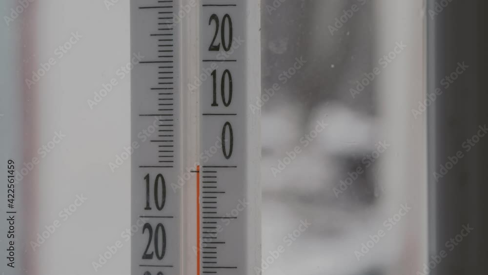 A thermometer with a negative temperature of 0 degrees Celsius outside ...