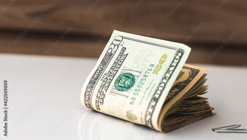 A wad of folded American dollars. Us Currency, USD, US Dollar. Money on ...