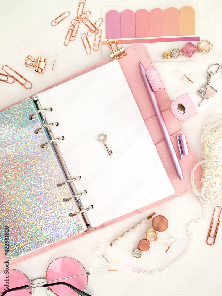 Silver key on the white page of the planner. Diary open with white and ...