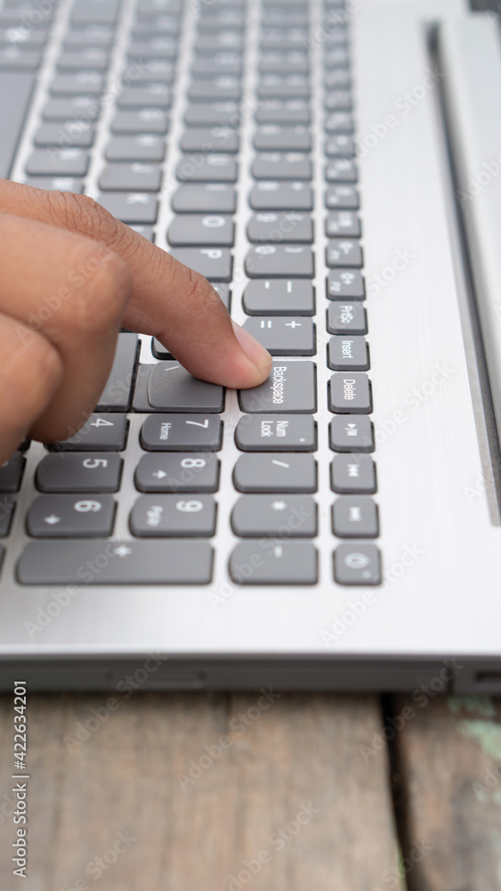 Latino hands using a computer. Brown fingers typing a laptop. Laptop ...