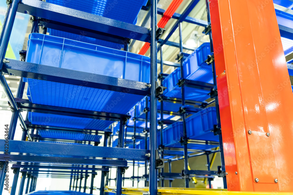 plastic boxes in the cells of the automated warehouse. Metal ...