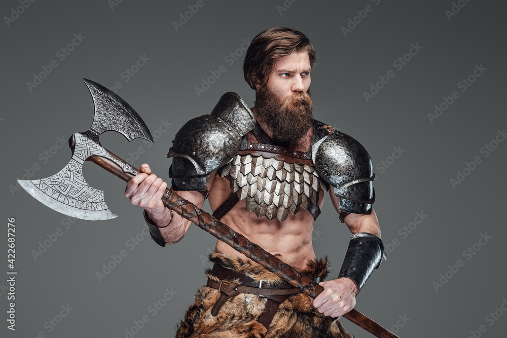 Scandinavian warrior holding a huge axe prepared to fight in gray ...