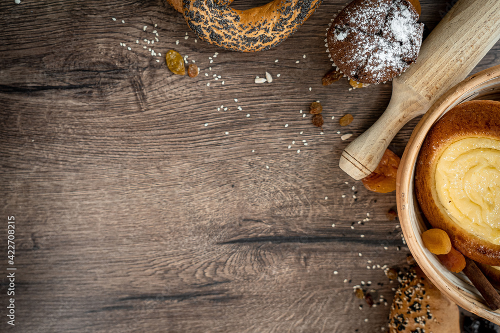 Variety of baked goods on wooden table background. Bakery concept gold ...