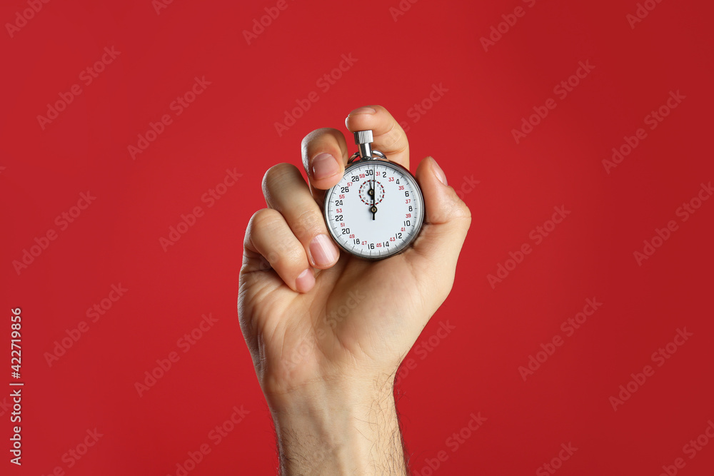 Man holding vintage timer on red background, closeup Stock Photo ...