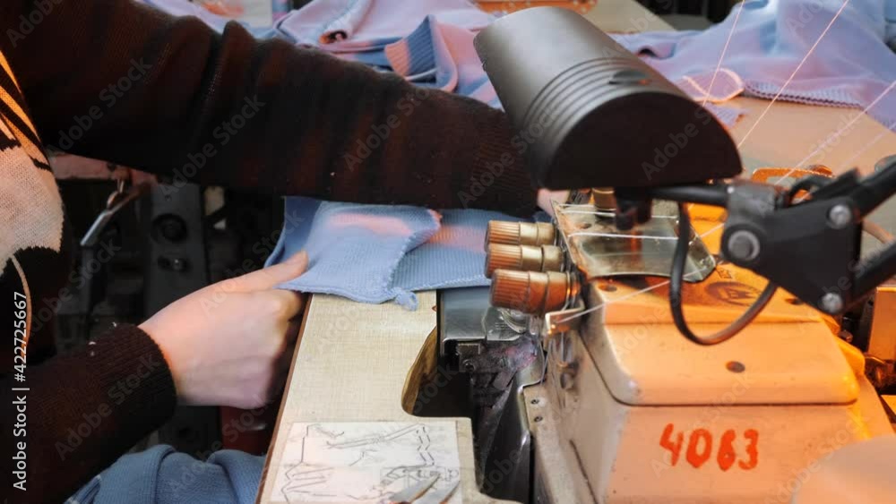 Female hands working on Tailoring. Overlock Sewing Machine Clothes ...