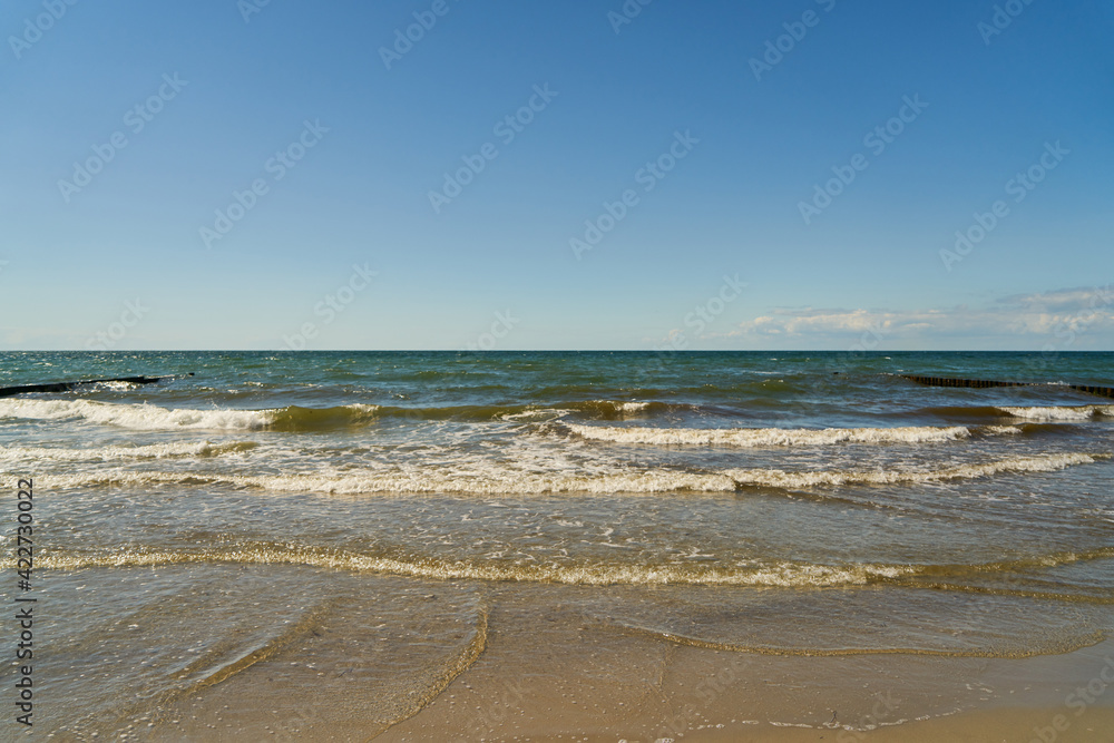 Wellen am Strand im Ostsee Meer vor blauem Himmel Stock Photo | Adobe Stock