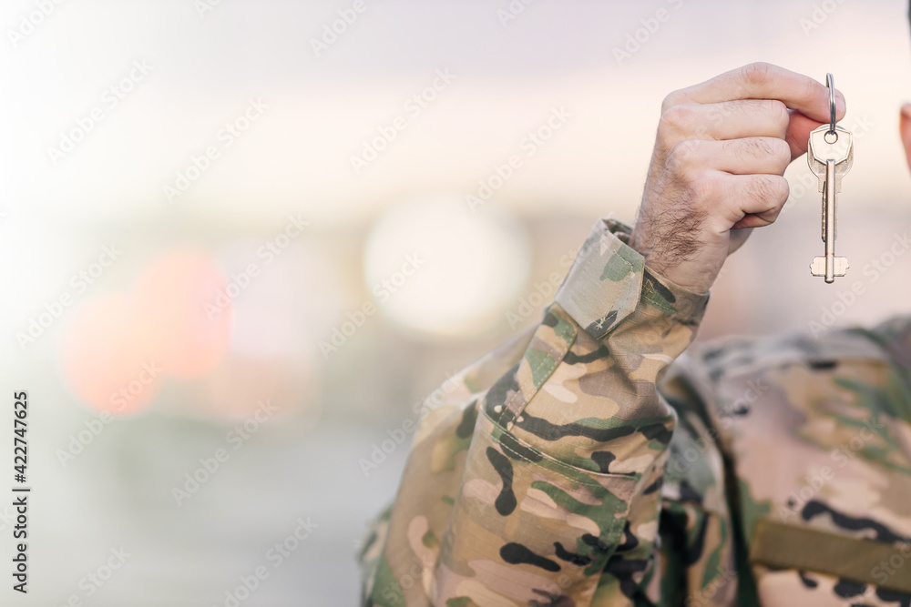 the hand of a patriotic military man in uniform holding the keys on a ...