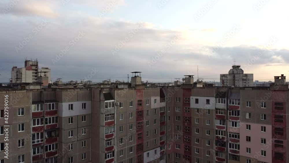 The drone rises above the roofs of old Soviet panel houses. Soviet ...