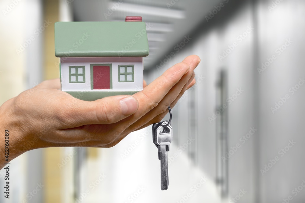 Human hand holding house model and keys Stock Photo | Adobe Stock