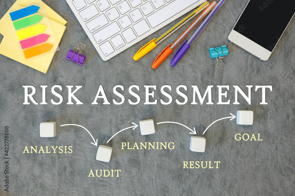 RISK ASSESSMENT CONCEPT. Office desk with accessories - coffee, notepad ...