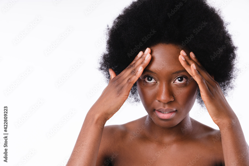 Good-looking young african girl looking for some facial problems ...