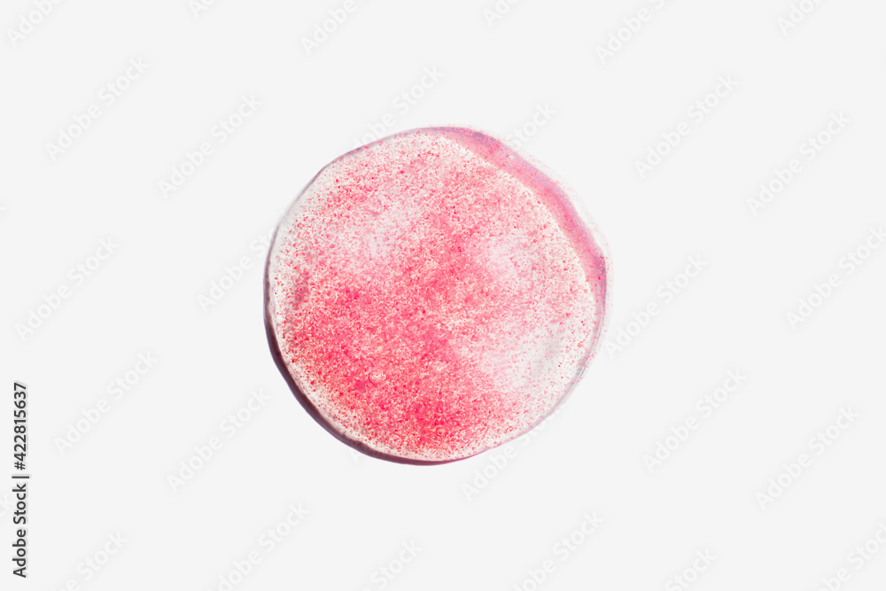 Pink transparent cosmetics drop on white background. Skincare scrub ...