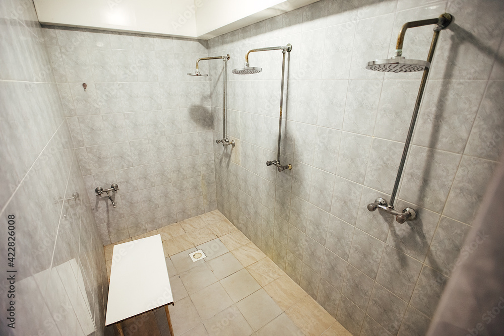 public shower in the gym locker room. wash up after sports. lots of ...