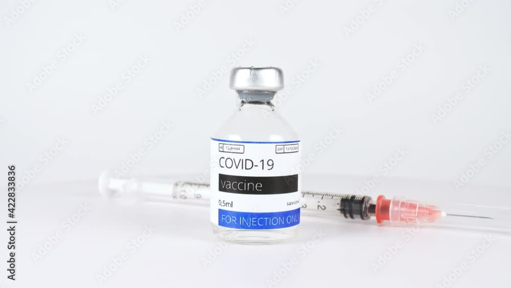 Covid-19 coronavirus vaccine. Syringe and vaccine vial. Treatment for ...