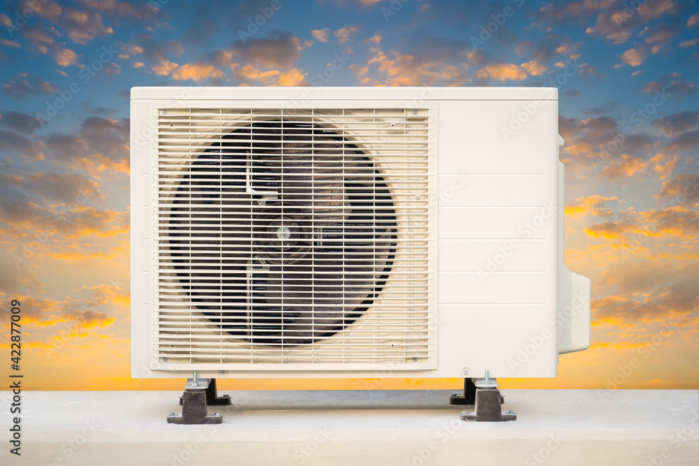 Condenser unit or compressor on roof of industrial plant building with ...