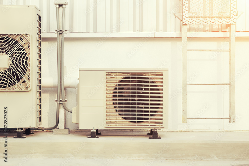 Condenser unit or compressor outside industrial plant building. Unit of ...