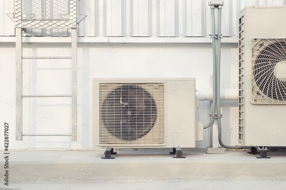 Condenser unit or compressor outside industrial plant building. Unit of ...