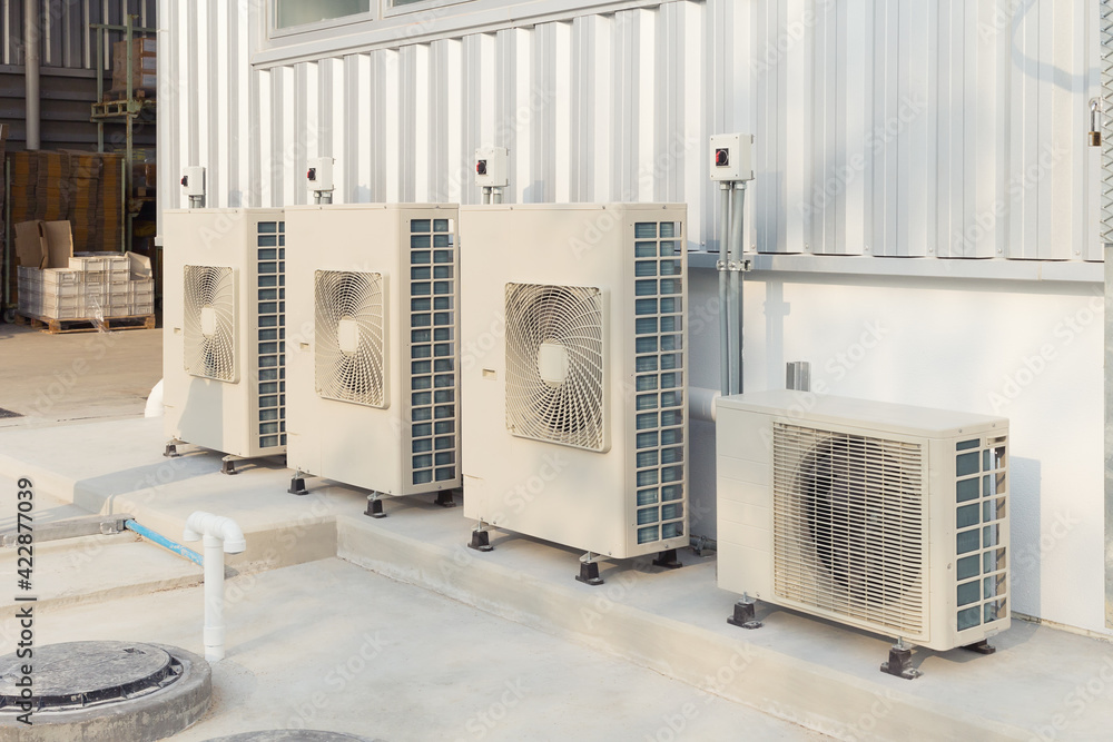 Condenser unit or compressor outside industrial plant building. Unit of ...