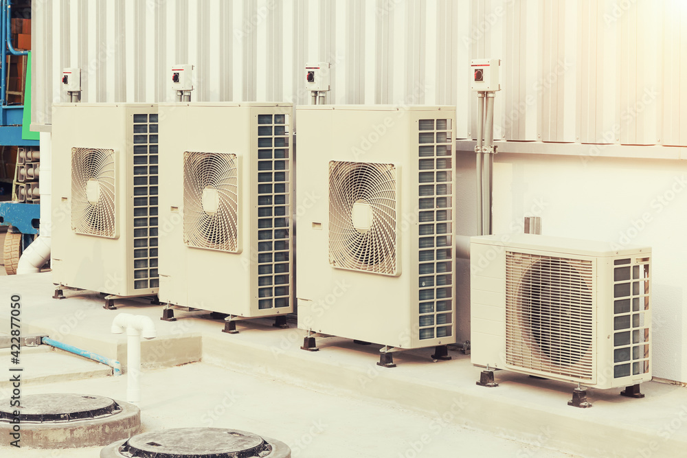 Condenser unit or compressor outside industrial plant building. Unit of ...