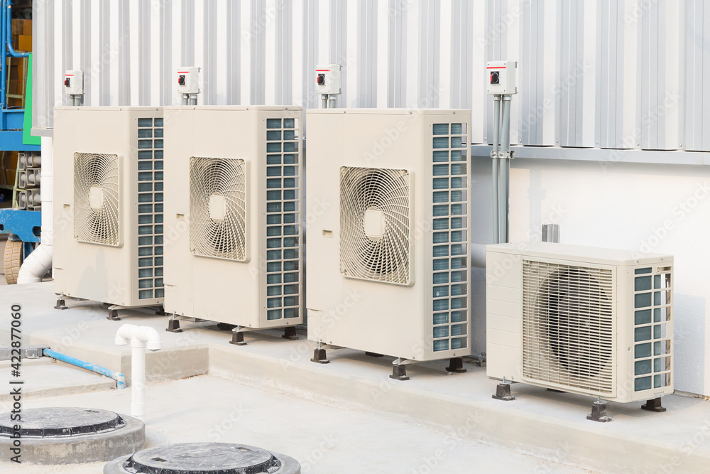 Condenser unit or compressor outside industrial plant building. Unit of ...