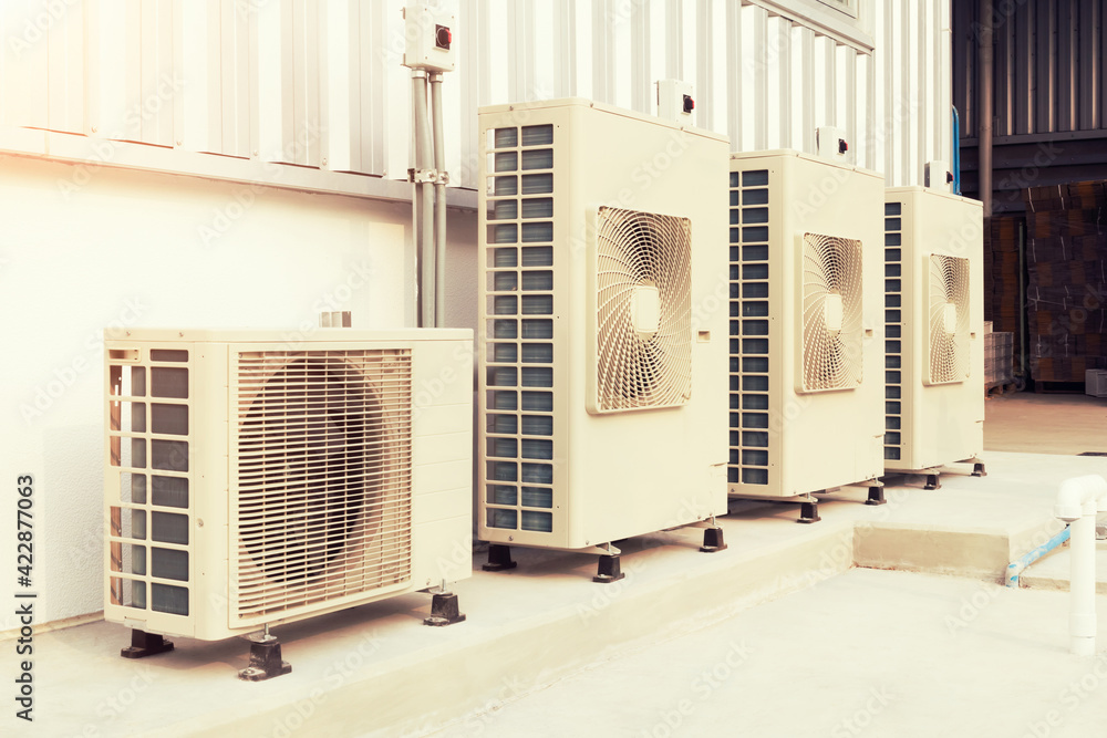 Condenser unit or compressor outside industrial plant building. Unit of ...