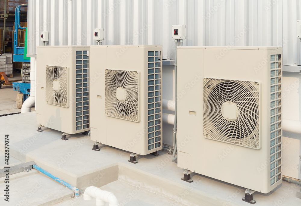 Condenser unit or compressor outside industrial plant building. Unit of ...