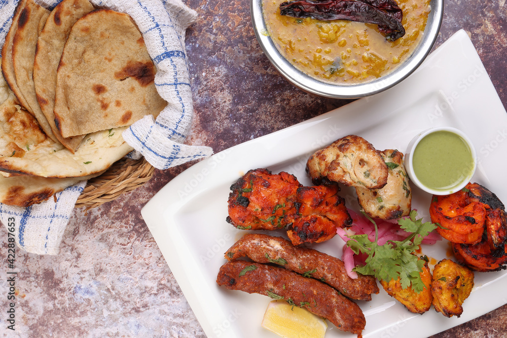 Mixed grill kebab chicken mutton beef prawn fish mint sauce lemon ...