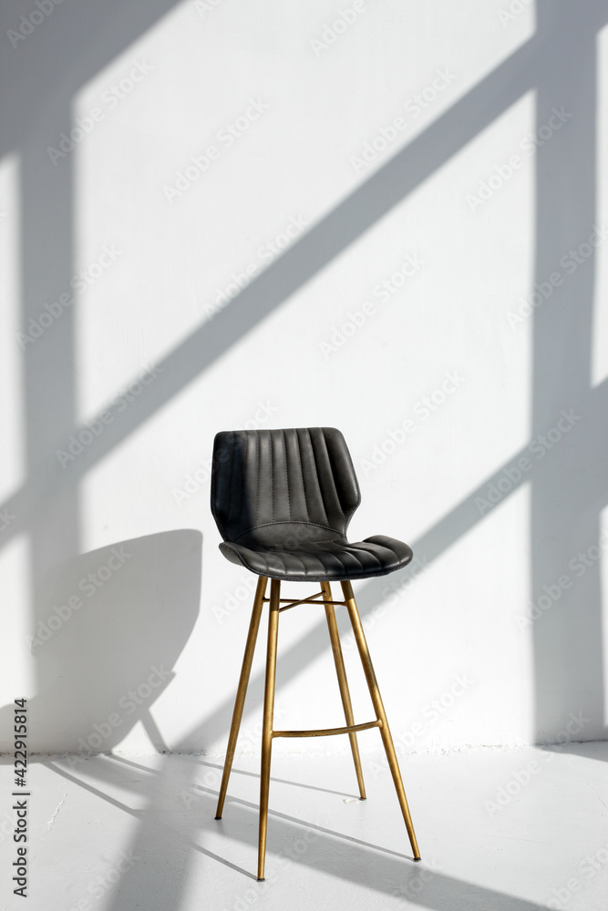 Empty modern chair in room, stine sunlight, white walls. Minimalistic ...