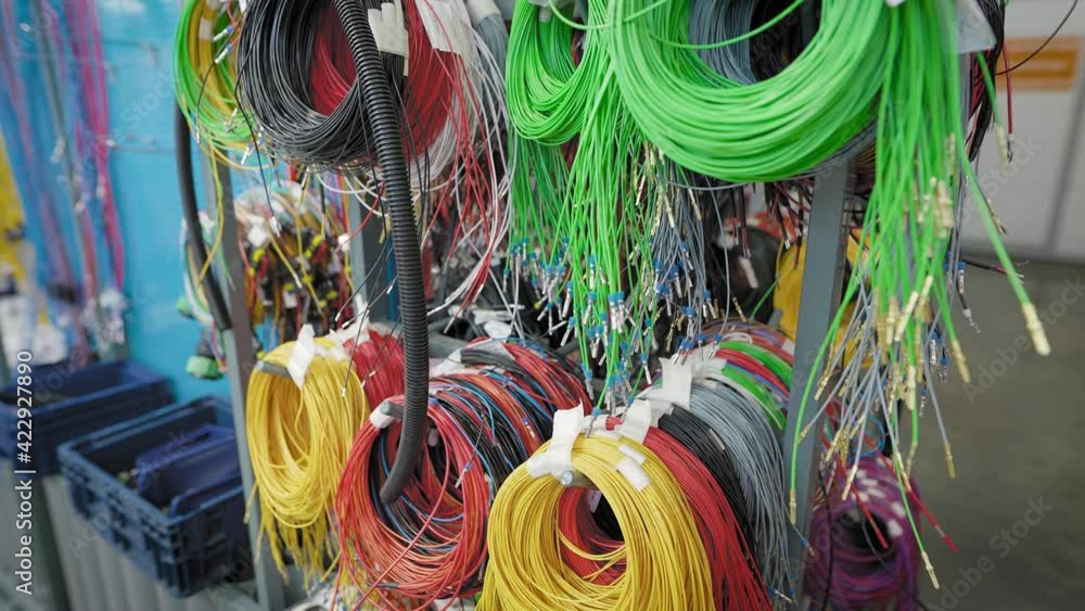 Colored wires in a workshop for the production of car wiring. Different ...