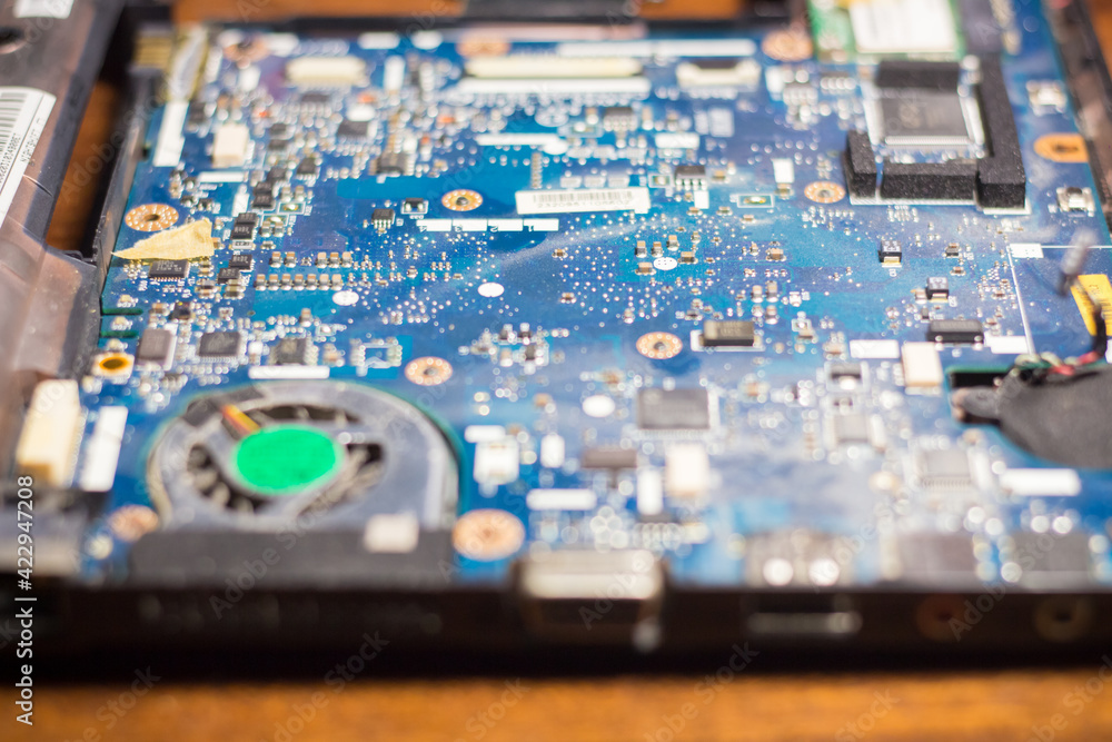 Laptop motherboard. Disassembling an old laptop Stock Photo | Adobe Stock