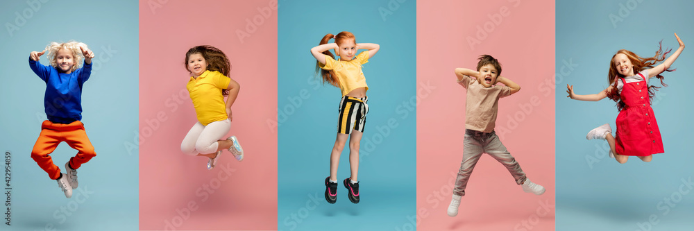 Young and happy kids gesturing isolated on multicolored studio ...