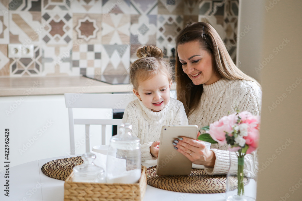 miling mother takes selfie with cute daughter on tablet, happy young ...