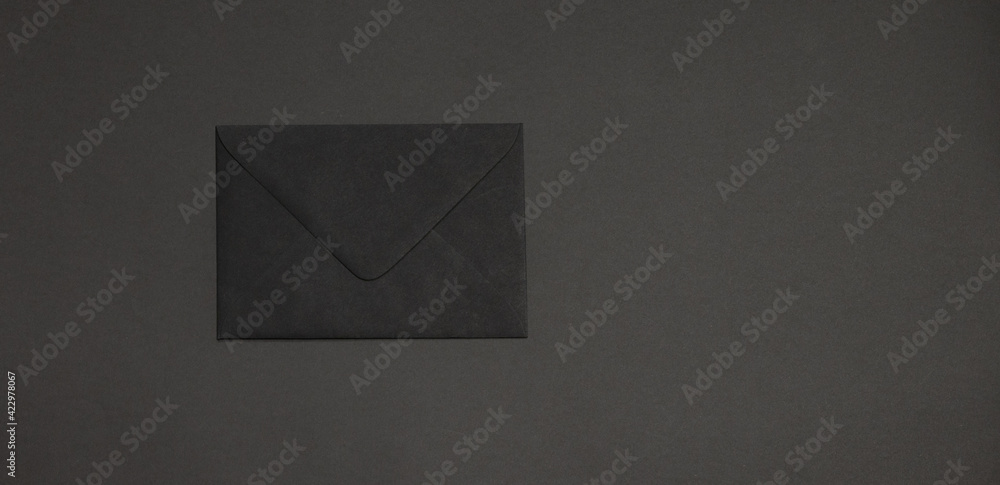 Black envelope on dark background. Template branding mockup. Copy space ...