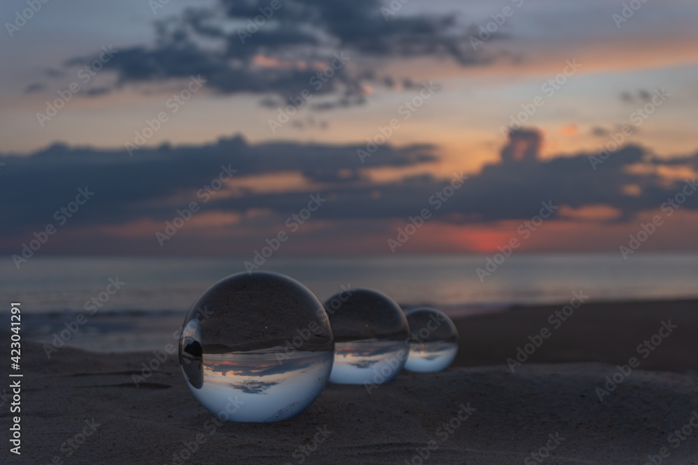 Three clear crystal balls of three sizes are sphere reveals seascape ...