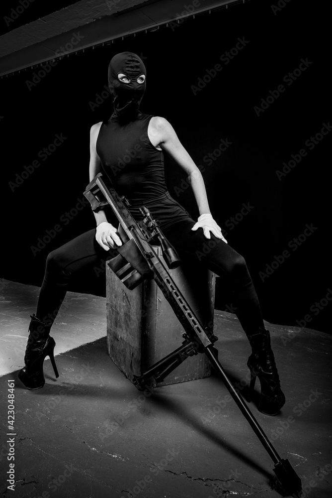 Sexy girl in black mask and black suit with sniper rifle Stock Photo ...