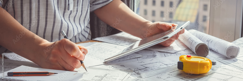 Architect works remotely from home in quarantine, lockdown covid 19 coronavirus. Remote work ...