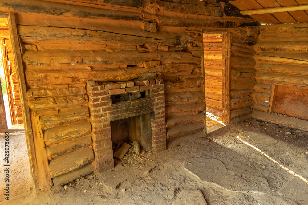 The living room with a brick fireplace, view of an adjacent room, doors ...